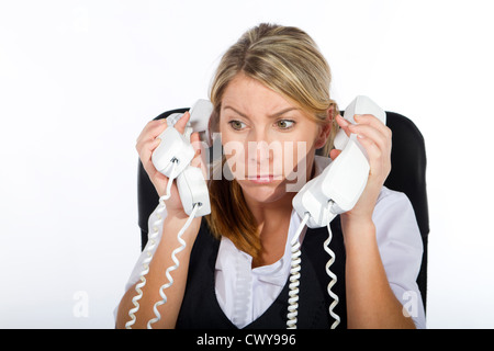 stressed young businesswoman dealing with a lot of phone calls at same ...