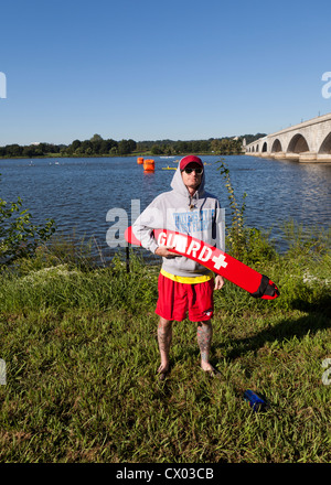 Male lifeguard with rescue float on yellow background with space for ...