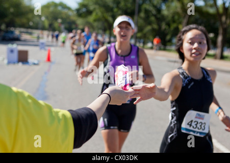 Marathon runner reaching for an energy gel packet - USA Stock Photo - Alamy