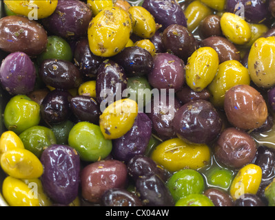 Mixed marinated olives (green and purple) on dark background. Tasty ...