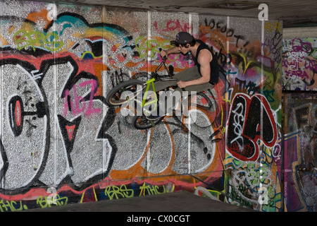 BMX freestyle bike riding 180 graffiti wall rider Stock Photo - Alamy