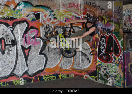 BMX freestyle bike riding 180 graffiti wall rider Stock Photo - Alamy