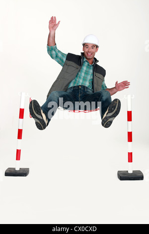 Man jumping over security chain Stock Photo - Alamy