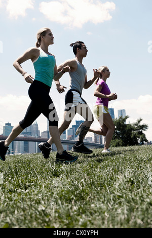 Three people jogging in the park with zoom blur Stock Photo - Alamy