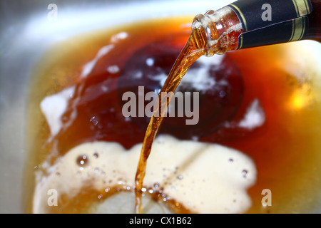 Beer being poured down the sink Stock Photo - Alamy
