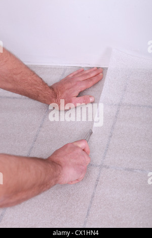 a man is fitting underlay Stock Photo - Alamy