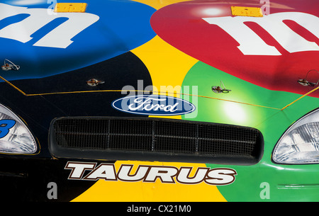 A Ford Taurus NASCAR race car covered in sponsor decals at the Roush ...