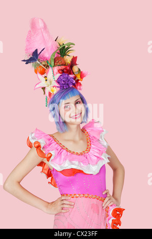 Hispanic woman standing over pink background covering one eye with hand ...