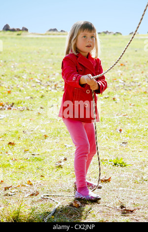 little girl pulling a rope Stock Photo - Alamy