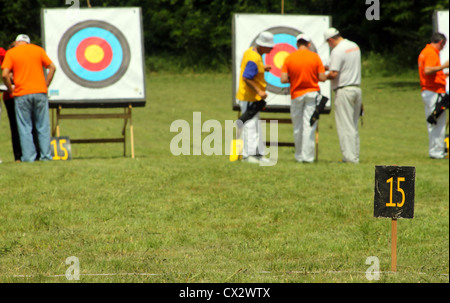 An archers aiming at archery target on a shooting range for archery ...
