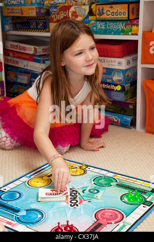 Little girl playing card game alone Stock Photo - Alamy