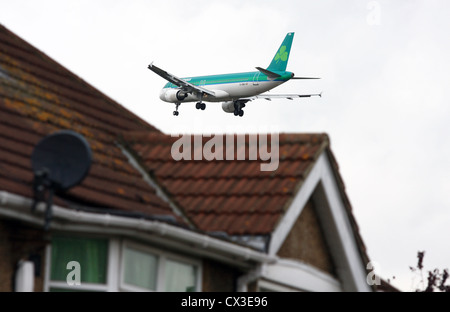 An aircraft flying over houses as it comes in to land at Heathrow ...