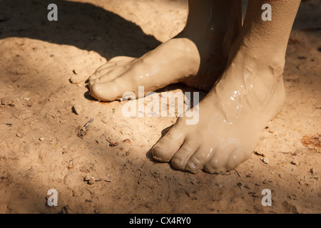 Feet in mud close-up, feet of a woman Stock Photo - Alamy