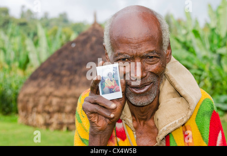 Sidama Tribe Ethiopia Africa old man age 82 portrait with his hut home ...