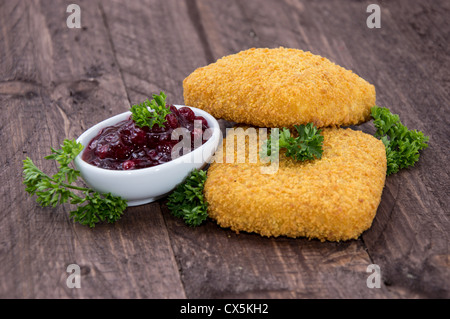 Portion of fried Gouda on wooden background Stock Photo - Alamy