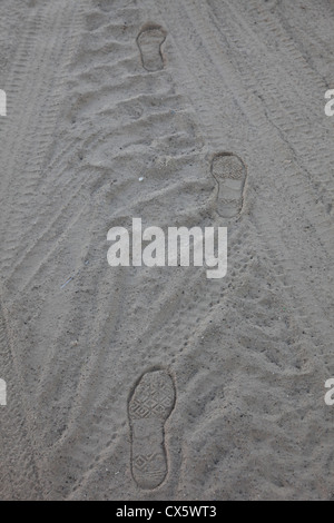 Trace of a human foot on the sand and arrows. Tourist traffic Stock ...