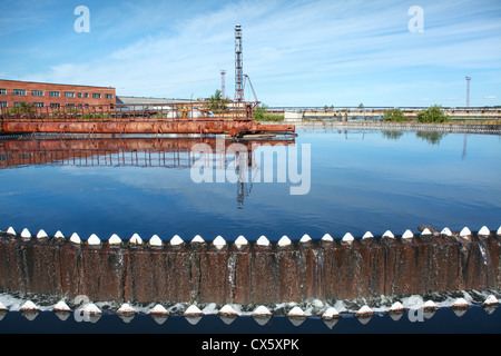 Water overflowing from industrial tank Stock Photo - Alamy