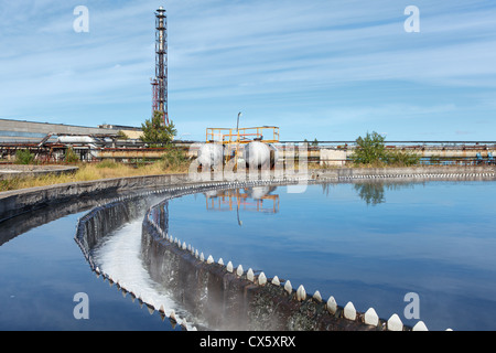 Water overflowing from industrial tank Stock Photo - Alamy