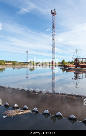 Water overflowing from industrial tank Stock Photo - Alamy