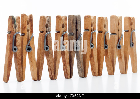 A bunch of clothes pins standing in front of a white background Stock ...