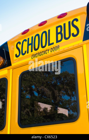 The rear of a yellow school bus with an emergency door Stock Photo - Alamy