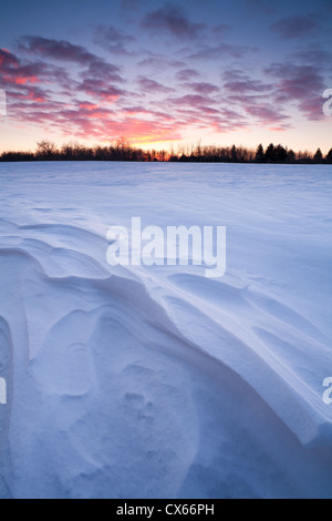Sunset in a cold white winter day landscape. Road through rural area ...
