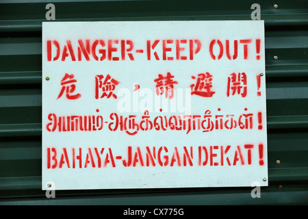Danger keep out sign in four languages, Singapore Stock Photo - Alamy