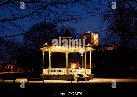 Bandstand in Hexham Park at night with floodlit Abbey. Northumberland ...