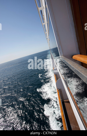 Idyllic view of wake in sea against cloudy sky Stock Photo - Alamy