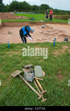 Excavation of a prehistoric site. Archaeologist drawing a diagram of ...
