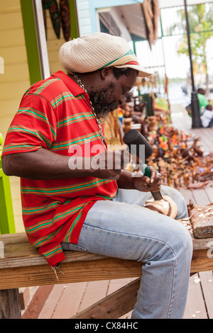 A wood carver works at the Straw Market in Nassau , Bahamas Stock Photo ...