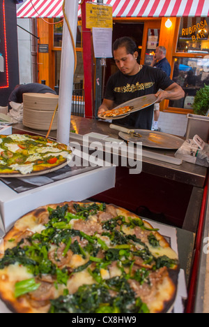 Street food vendor selling pizza from a converted horse trailer at the ...