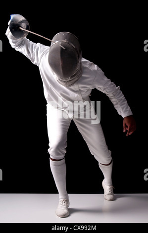Male fencer isolated in a dark background Stock Photo - Alamy