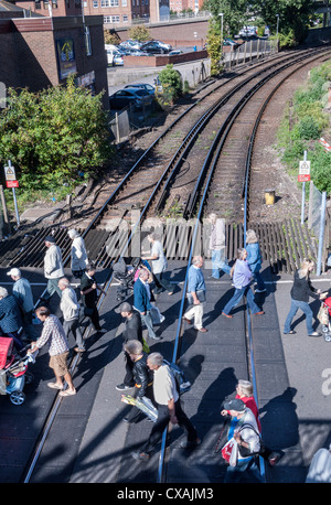 Poole Station, People at Railway Level Crossing Barrier with Train ...