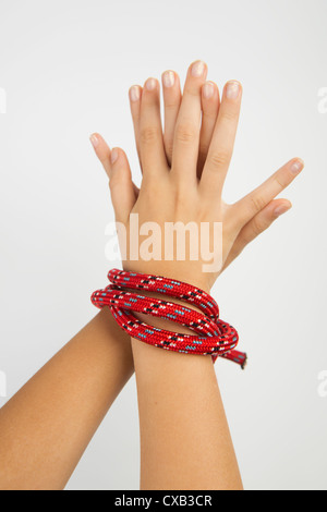 Woman tied with a rope by the hands, hanging Stock Photo - Alamy