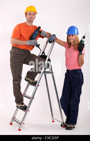 Experienced tradesman posing with apprentice Stock Photo - Alamy