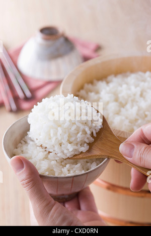 Human Hand Serving Steamed Rice in Rice Bowl Stock Photo - Alamy