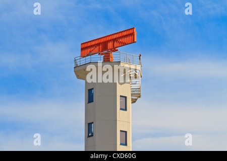 Red and white communication tower on blue sky Stock Photo - Alamy