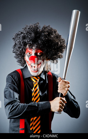 Funny clown with bat in studio Stock Photo - Alamy