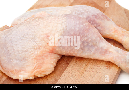 Two fresh raw chicken thighs with skin on a wooden board. Rustic ...