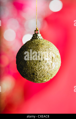 Golden christmas bauble on a string, isolated on white Stock Photo - Alamy