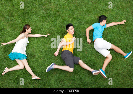 young people playing chase game on grass Stock Photo - Alamy