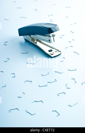 Stapler and clips closeup, blue background Stock Photo - Alamy