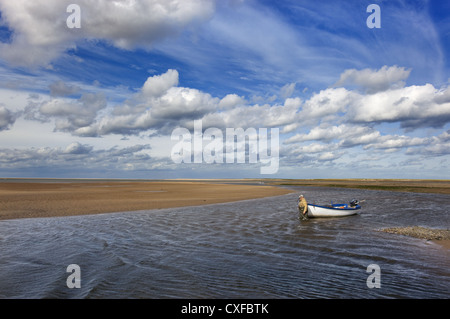 Mussel fisherman returning on river Stiffkey in Blakeney Harbour ...