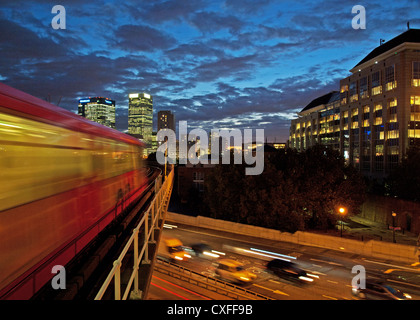 Night view of DLR train at East India DLR station showing Canary Wharf ...