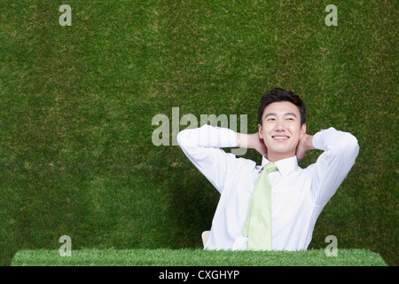 man sitting and leaning against the chair Stock Photo - Alamy