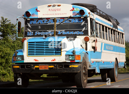 Brightly decorated local bus (chicken bus) picking up passengers in Old ...