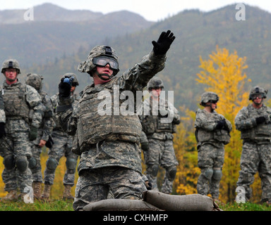 Pvt. John Long of the 545th Military Police Company practices throwing ...