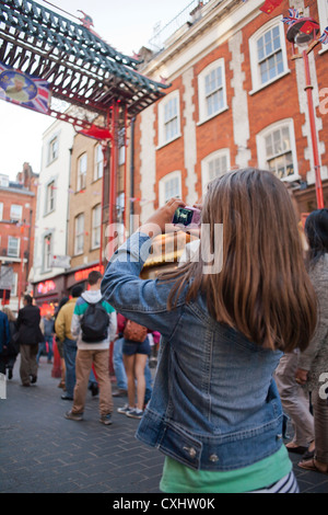Girl photographing Chinese arch in China Town London Stock Photo - Alamy