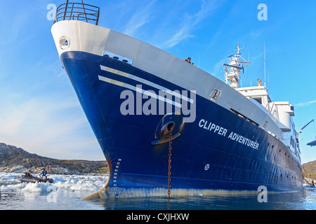 Cruise ship Clipper Adventurer sits at anchor in ice choked harbor of ...